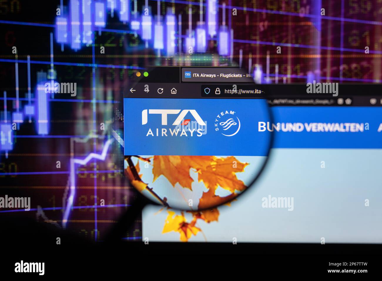 ITA Airways company logo on a website with blurry stock market developments in the background ...