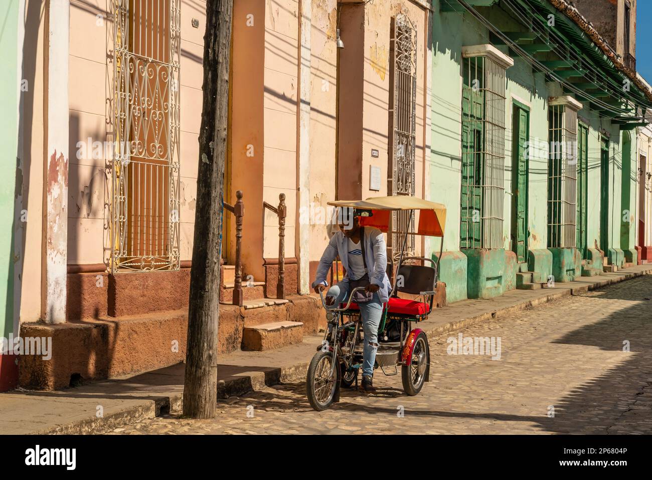 Bicycle buggy named Ferrari going down a cobblestone street, Trinidad ...