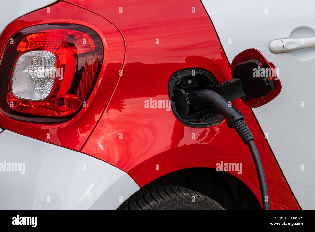 Red-white electric car charging with copy space. Technology electric ...