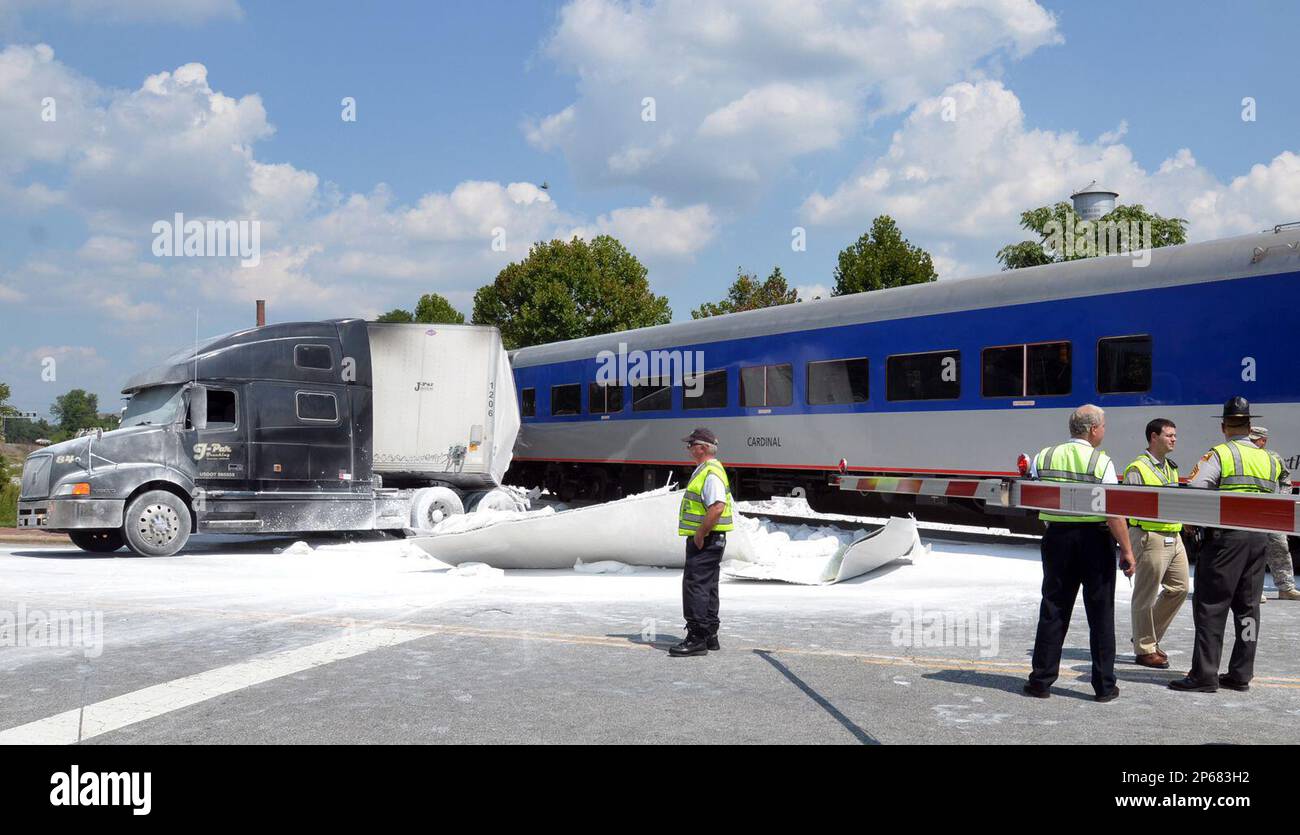 Emergency workers survey the scene after the Amtrak Carolinian struck a ...