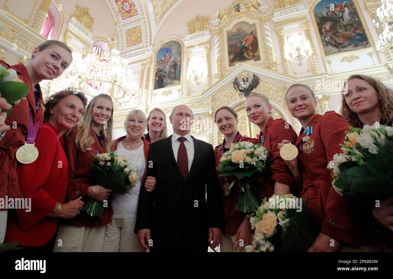 Russian President Vladimir Putin, center, poses for a picture with the ...