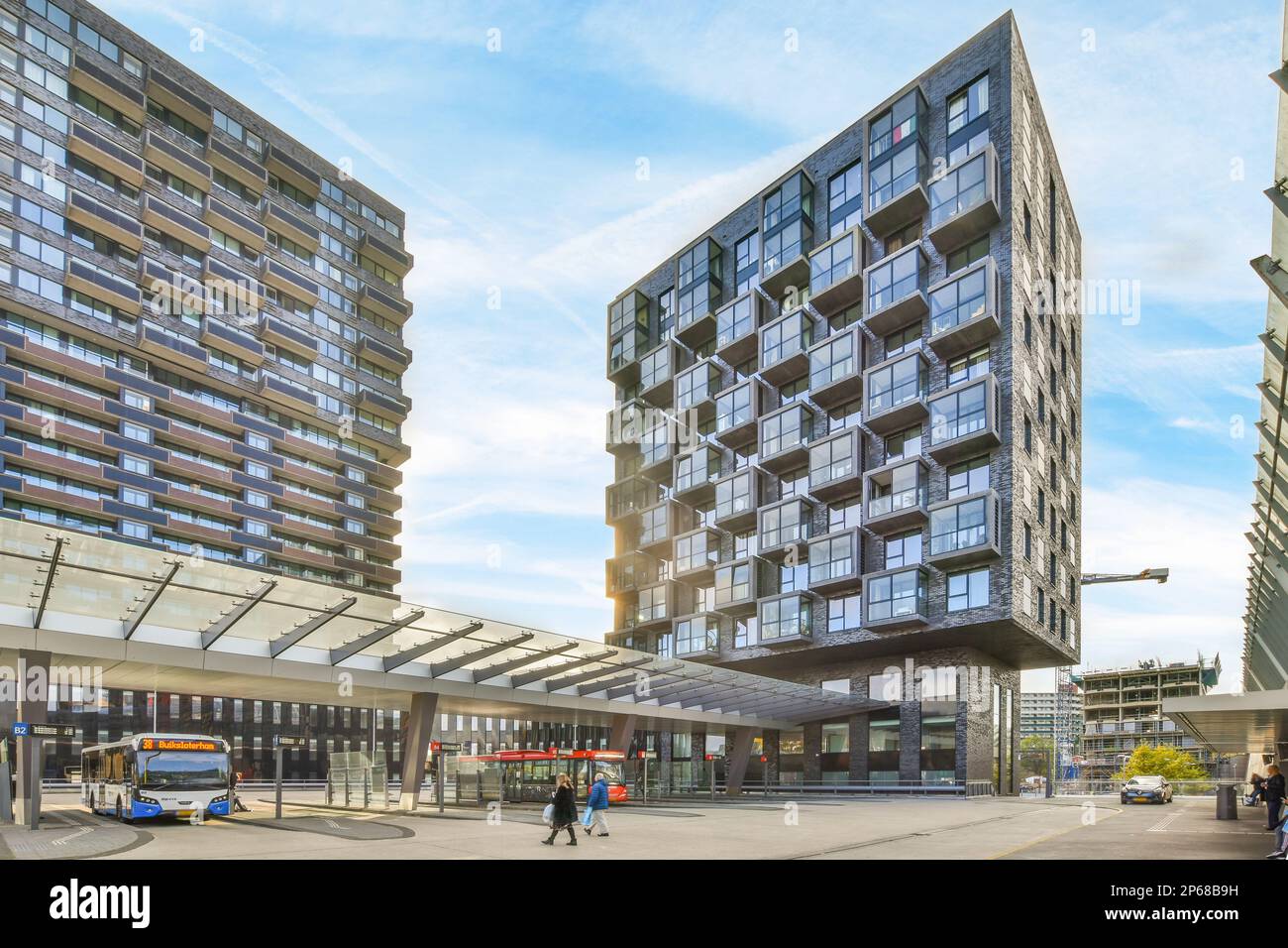 some buildings and people walking on the street in front of one another ...