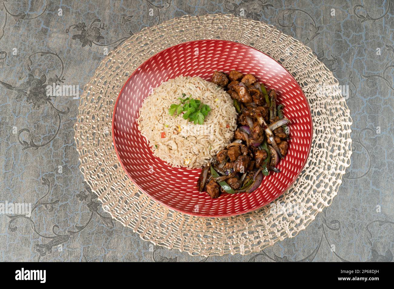 Chicken dry chili with a bowl of fried rice on textured background ...