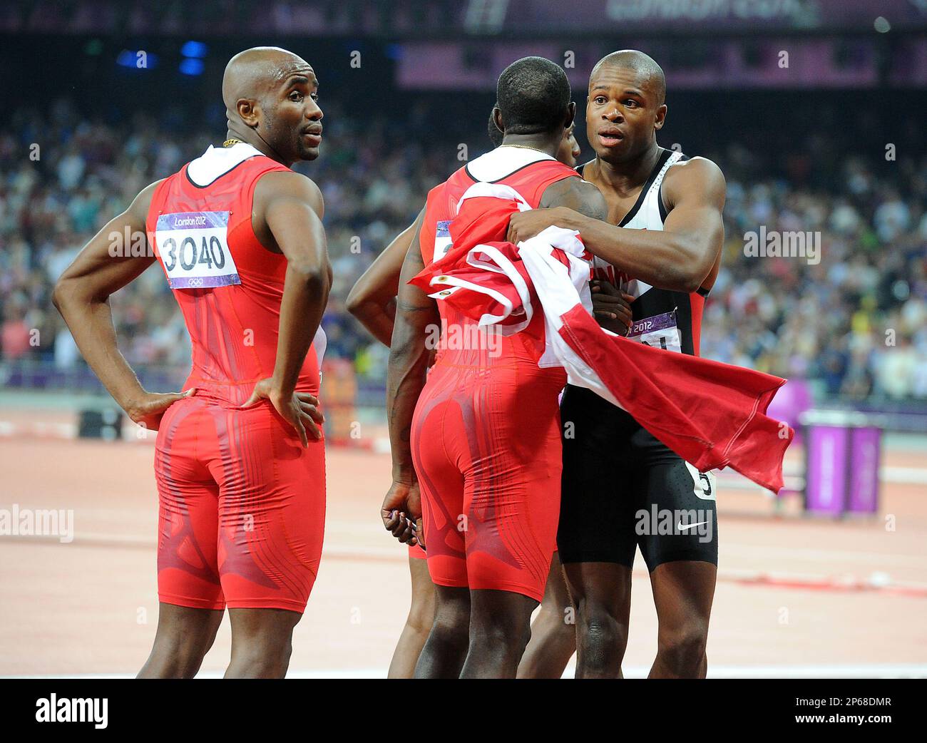 Trinidad and Tobago's Men's 4 x 100m Relay team comiserate with Oluseyi ...