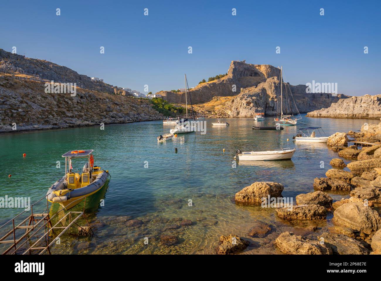 View of sailboats in St. Paul's Bay, Lindos, and Lindos Acropolis from ...