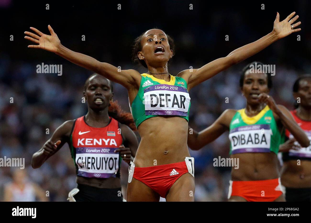 Ethiopia's Meseret Defar reacts as she crosses the finish line to win ...