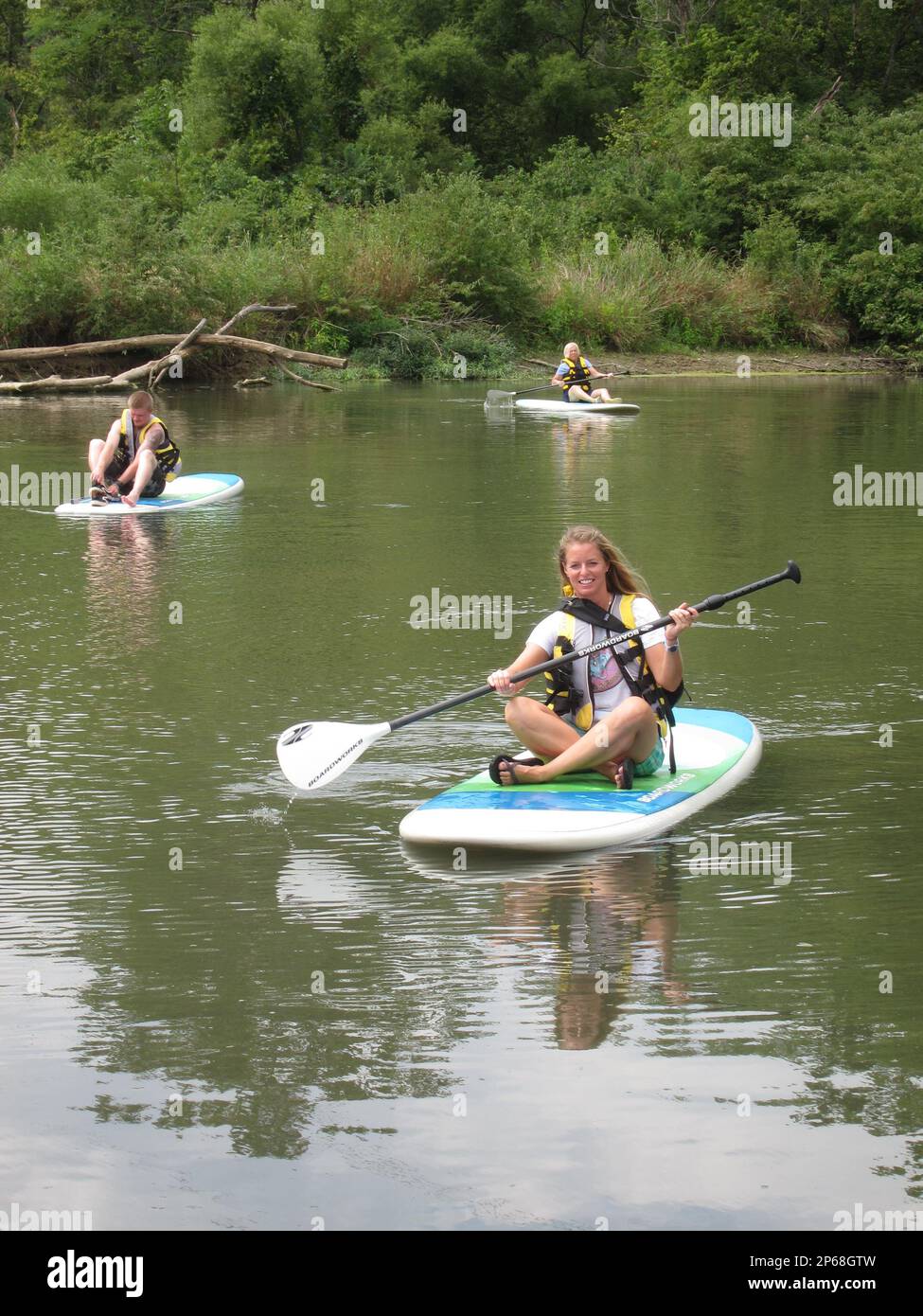 In this July 27, 2012 photo, Jodi Bratch, front, paddles into shore ...