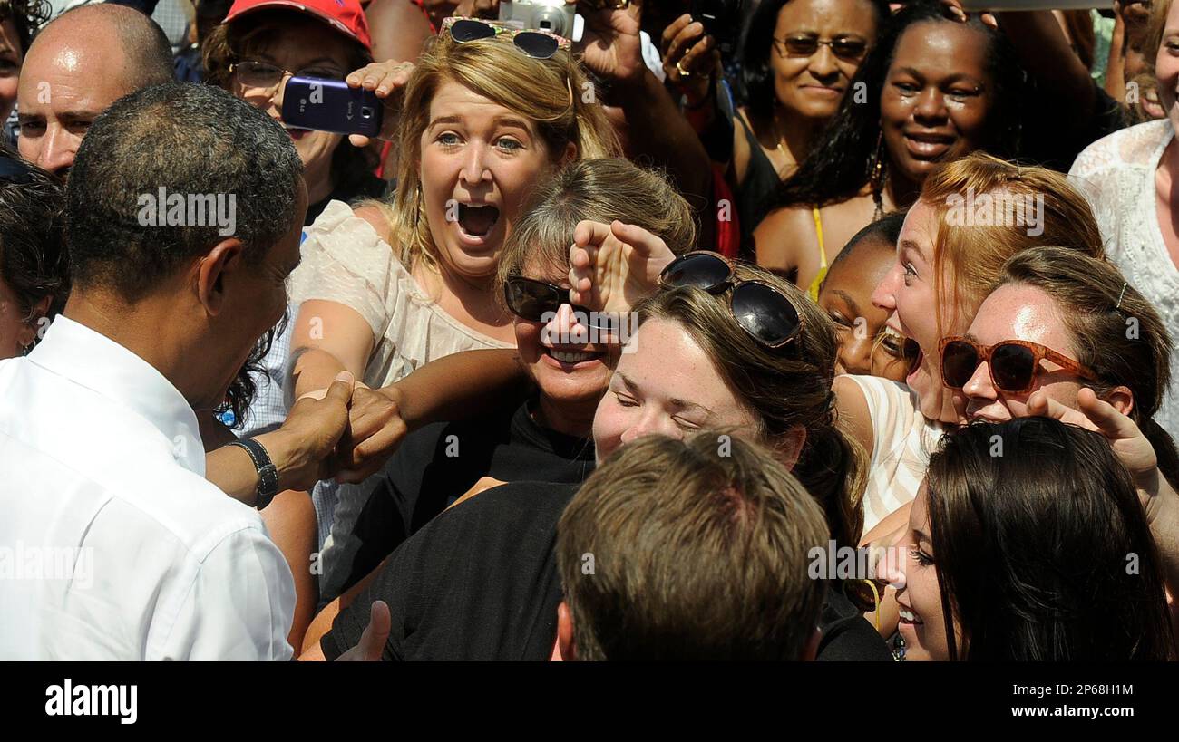A crowd reaches out to meet President Barack Obama at Colorado College ...