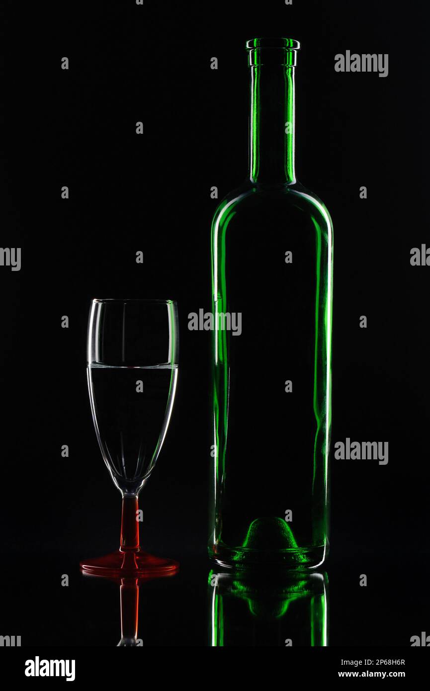 full glass bottle and white wine on black background Stock Photo - Alamy