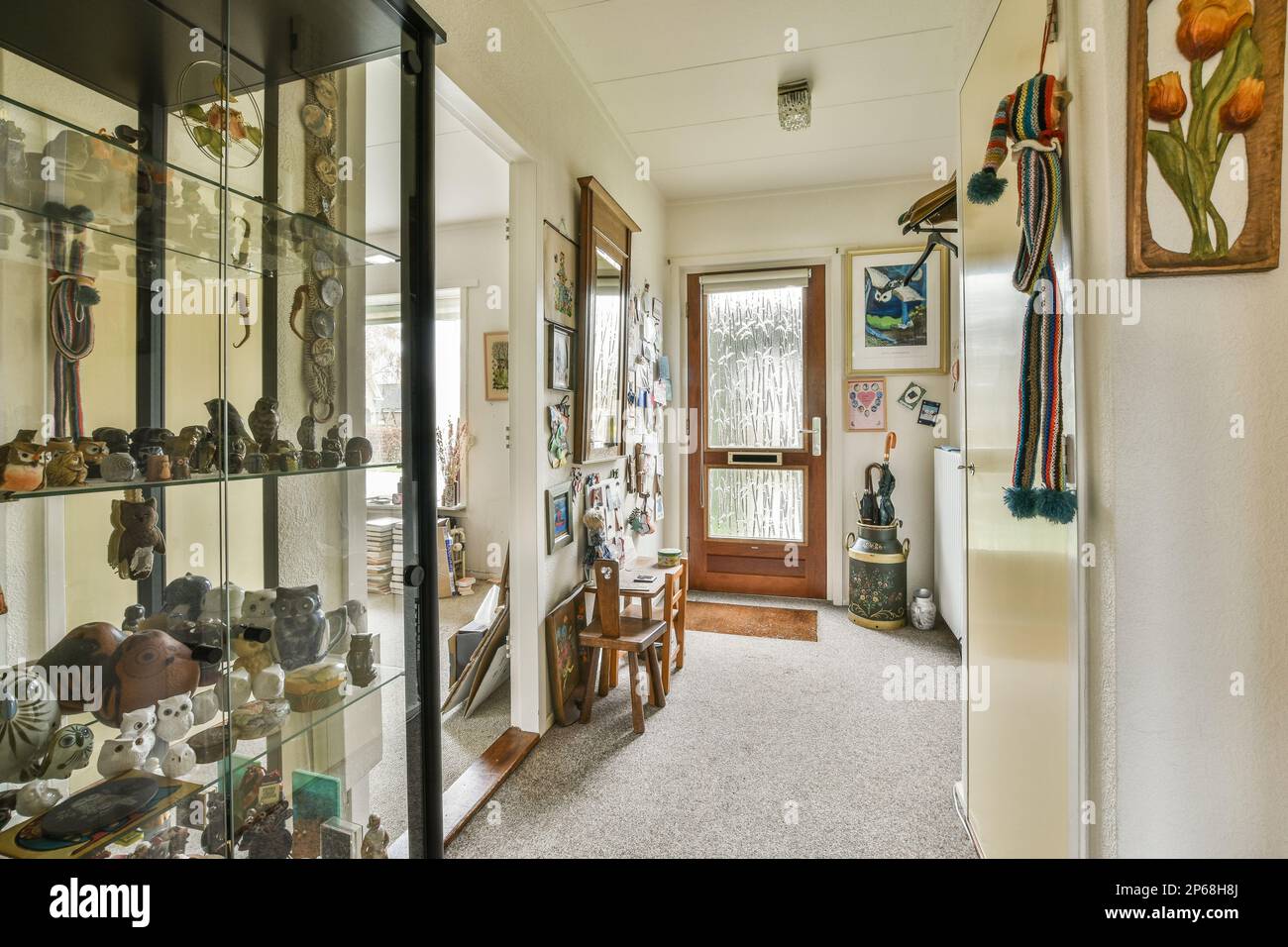 a glass display case in a room with various objects on the wall and ...