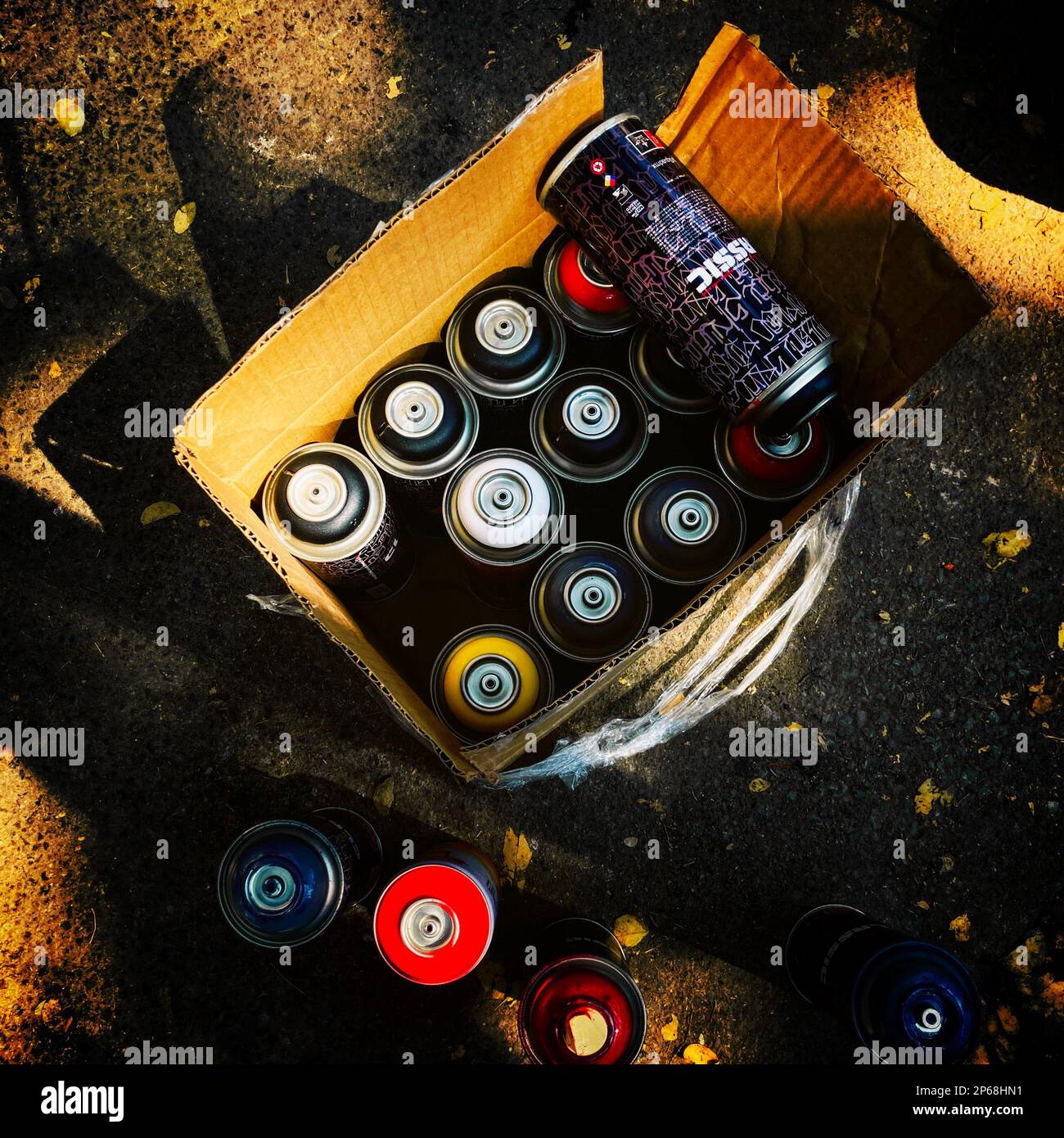 A cardboard box of spray paint cans is seen placed on the ground during ...