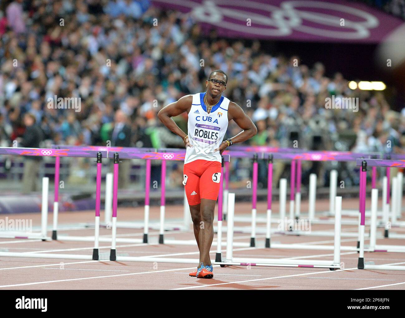 Cuba's defending champion Aries Dayron Robles pulled up midway through ...