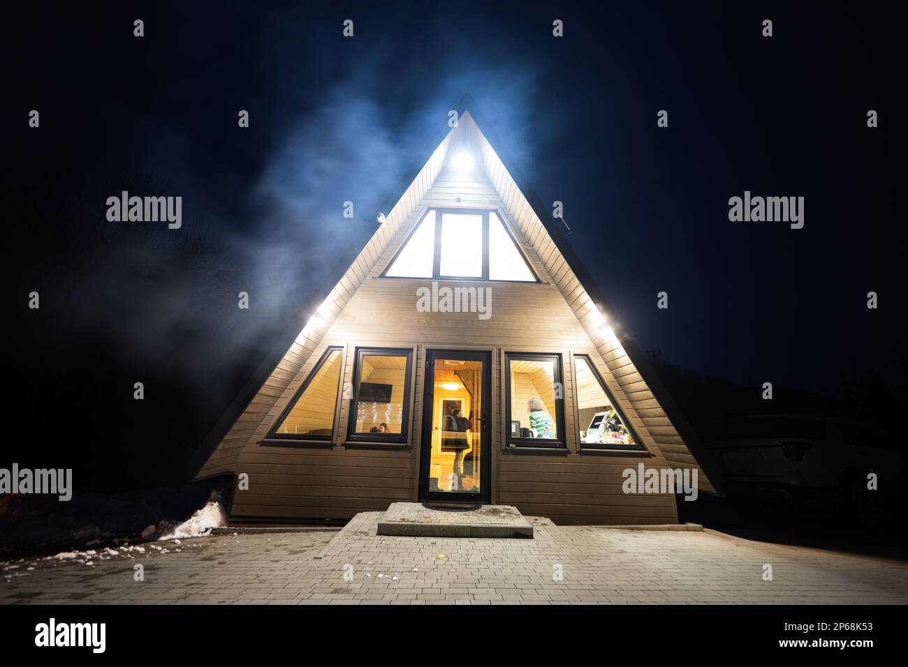 Triangle country house at night with smoke from bonfire Stock Photo - Alamy