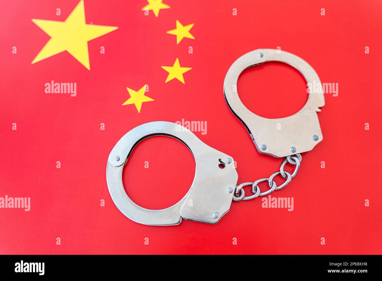 China flag and police handcuffs. The concept of observance of the law ...
