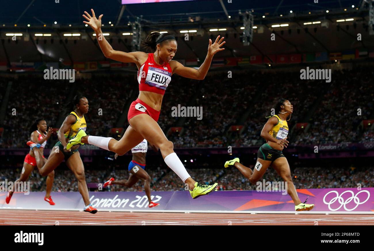 United States' Allyson Felix, second from right, crosses the finish ...