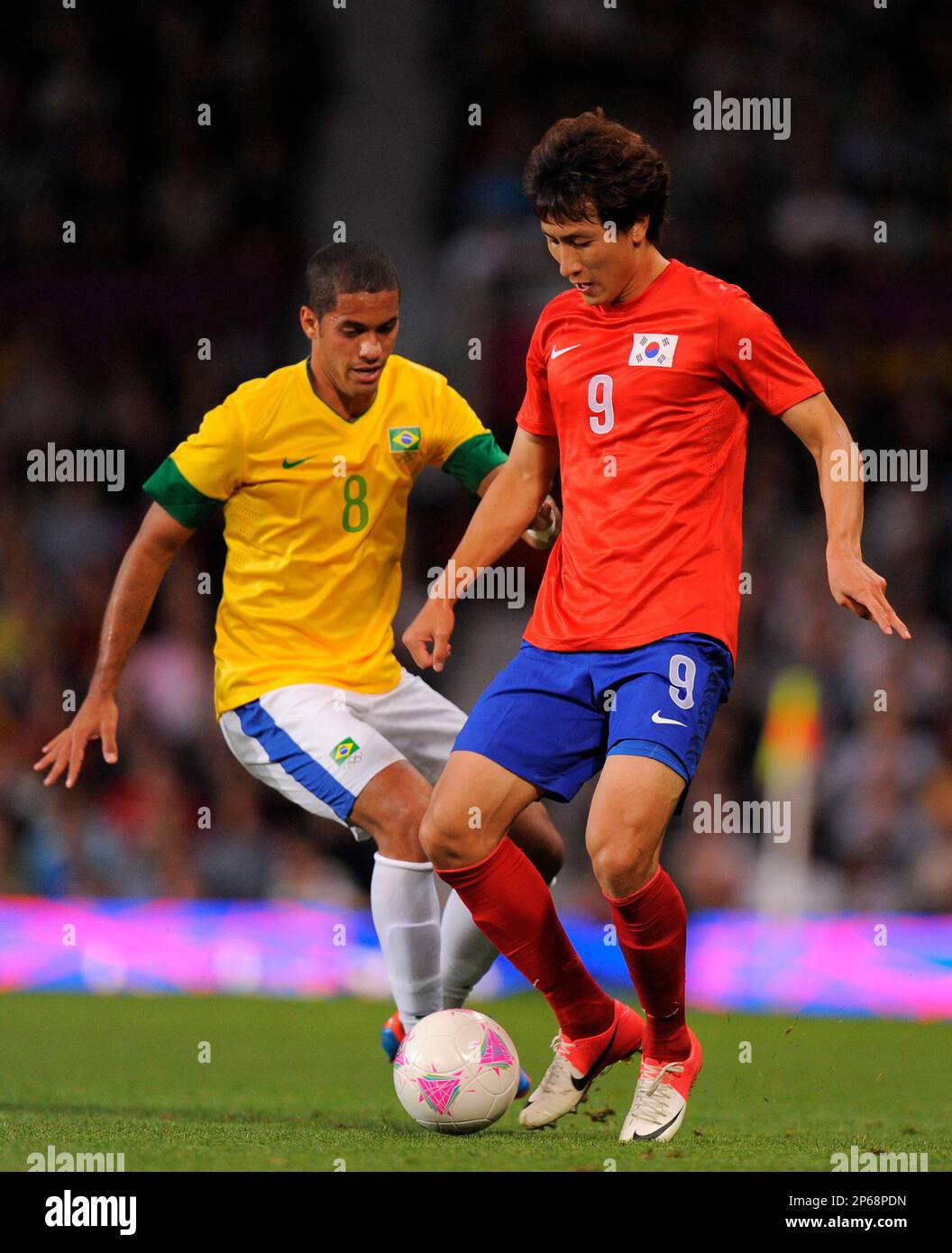 South Korea's Ji Dong-won tussles with Brazil's Romulo.South Korea v ...
