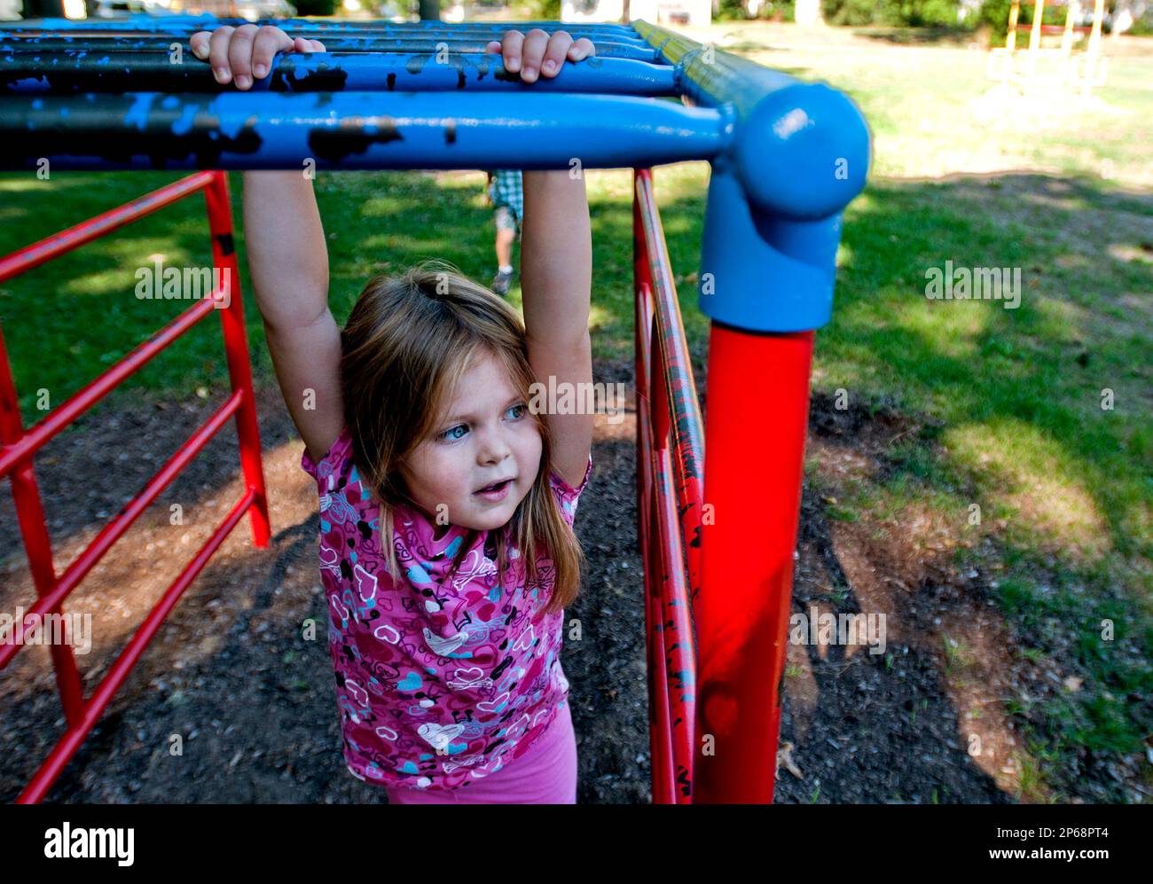 Kindergartener Alexis Hankins, 5, plays on a set of mini monkey bars ...