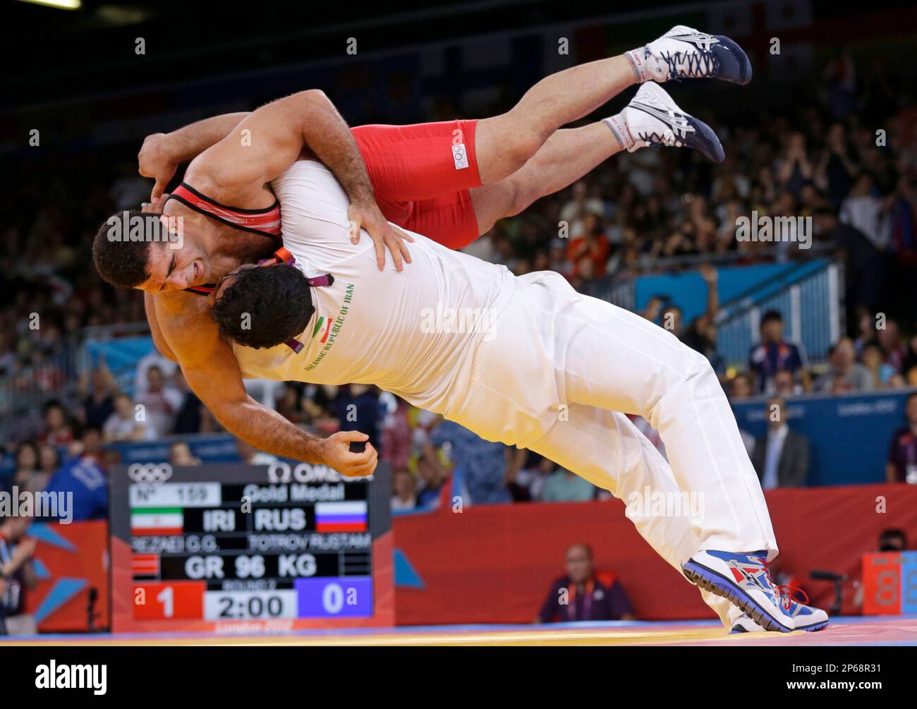 Iran's Ghasem Gholamreza Rezaei celebrates with his coach after ...