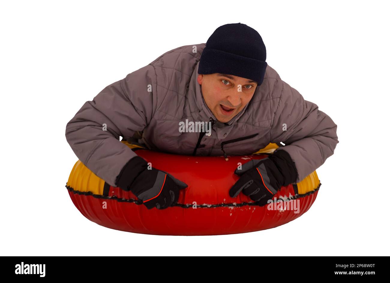 A man with fright and delight snow tubing from hill isolated on a white ...