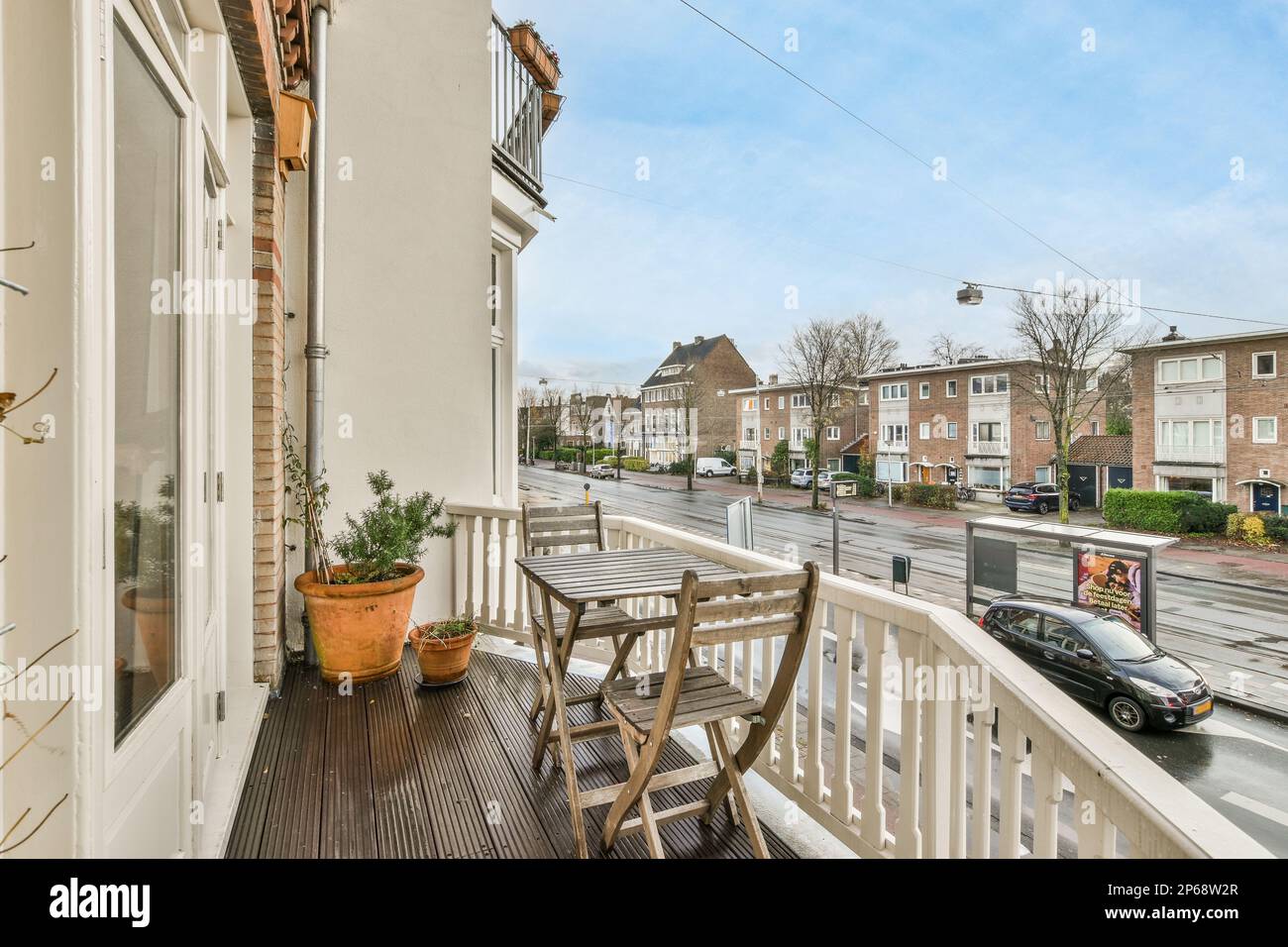 a balcony with chairs and tables on the front porch looking out to the ...