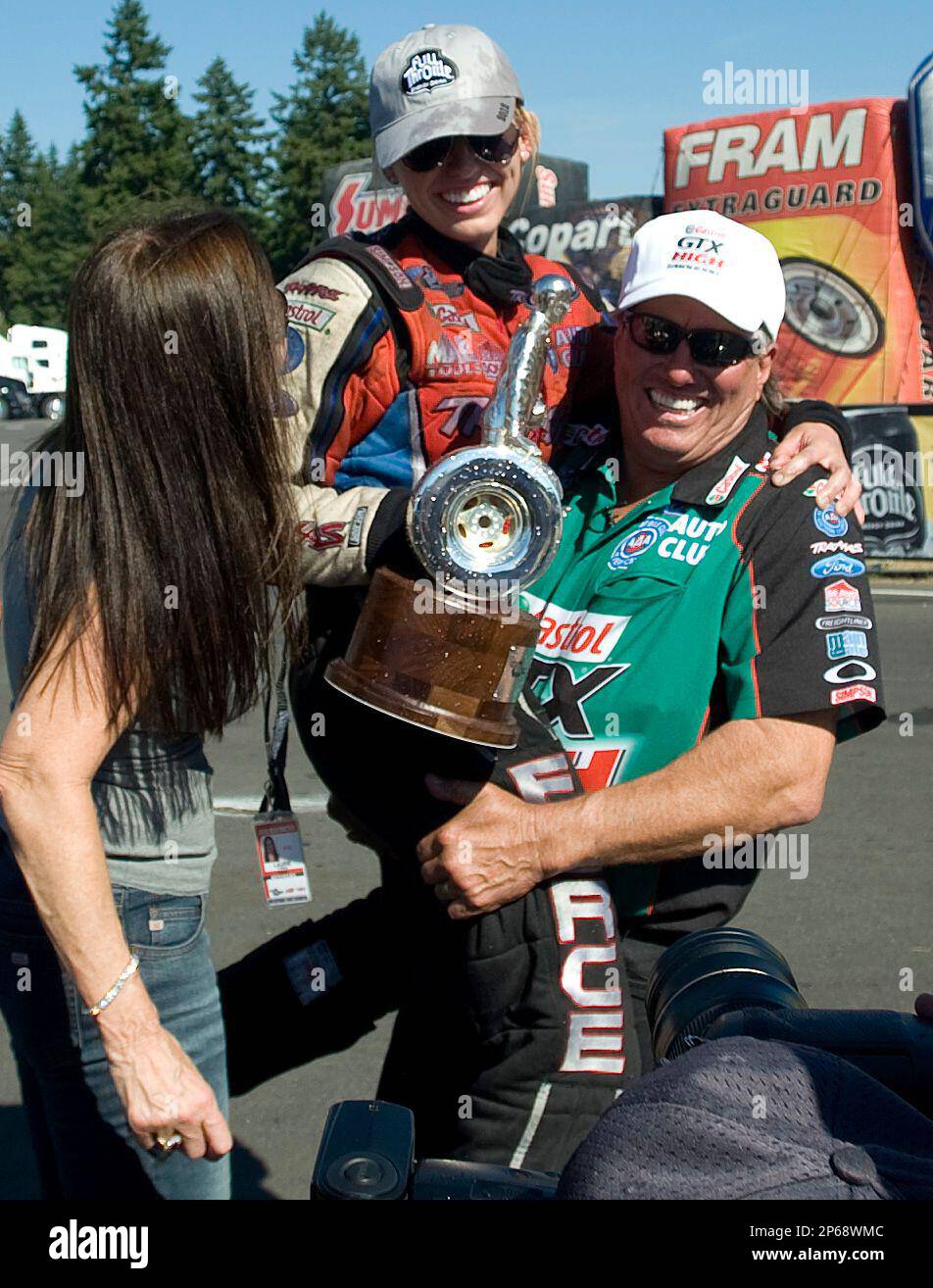 Courtney Force, center, celebrates her victory with her father John ...