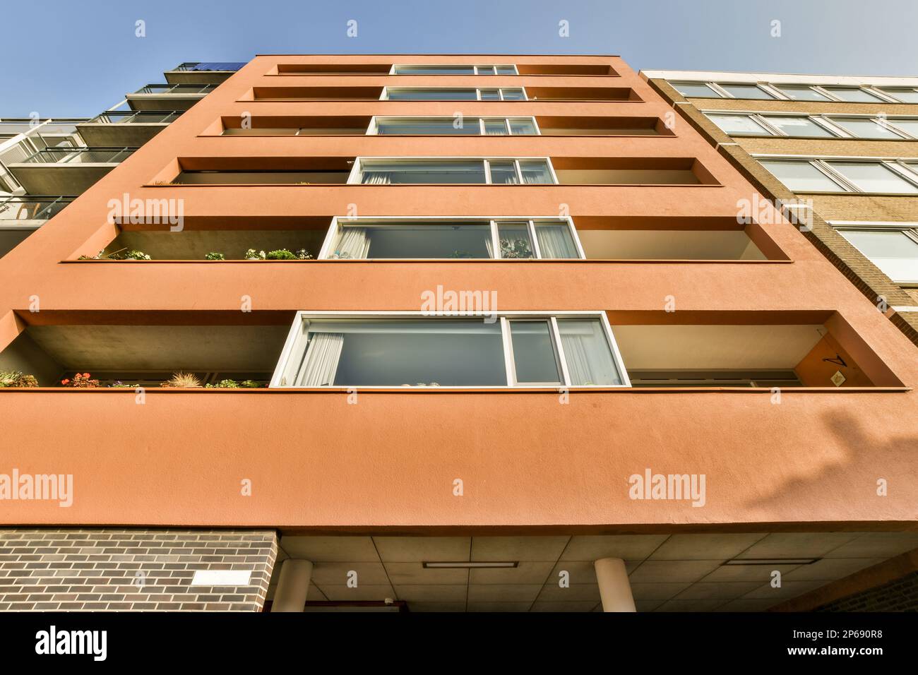 an apartment building with plants growing on the balk's window ledges ...