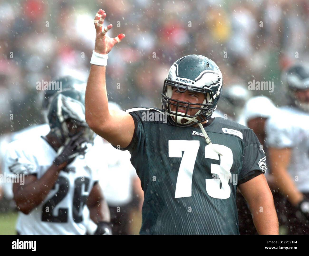 Philadelphia Eagles offensive lineman Julian Vandervelde holds his bleeding hand up to the rain ...