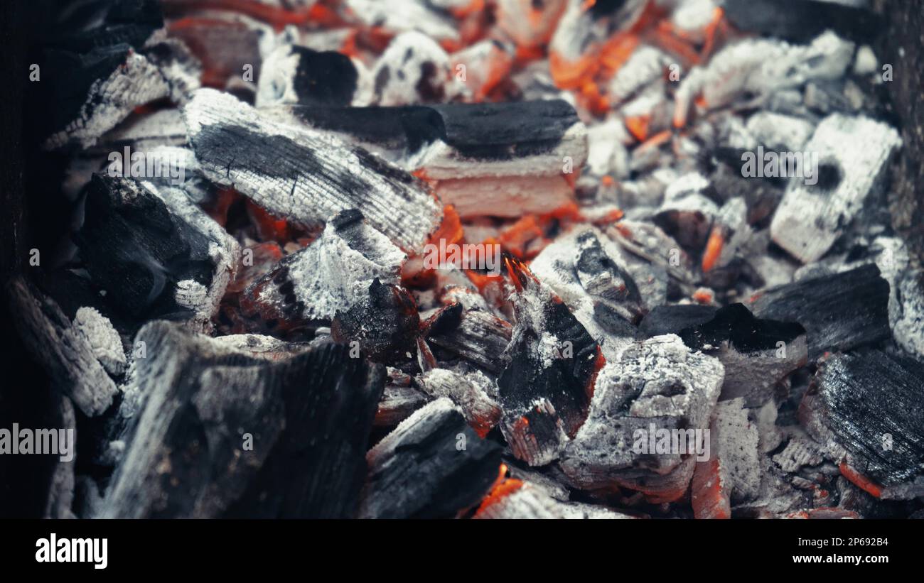 Metal grill with coals. Grilled meat. The fire is smoldering in the ...