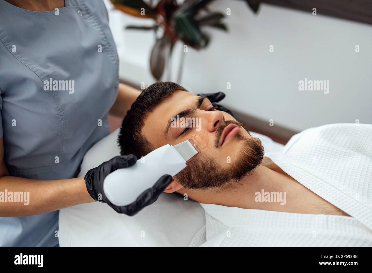 Beautician makes facial skin procedure hi-res stock photography and ...
