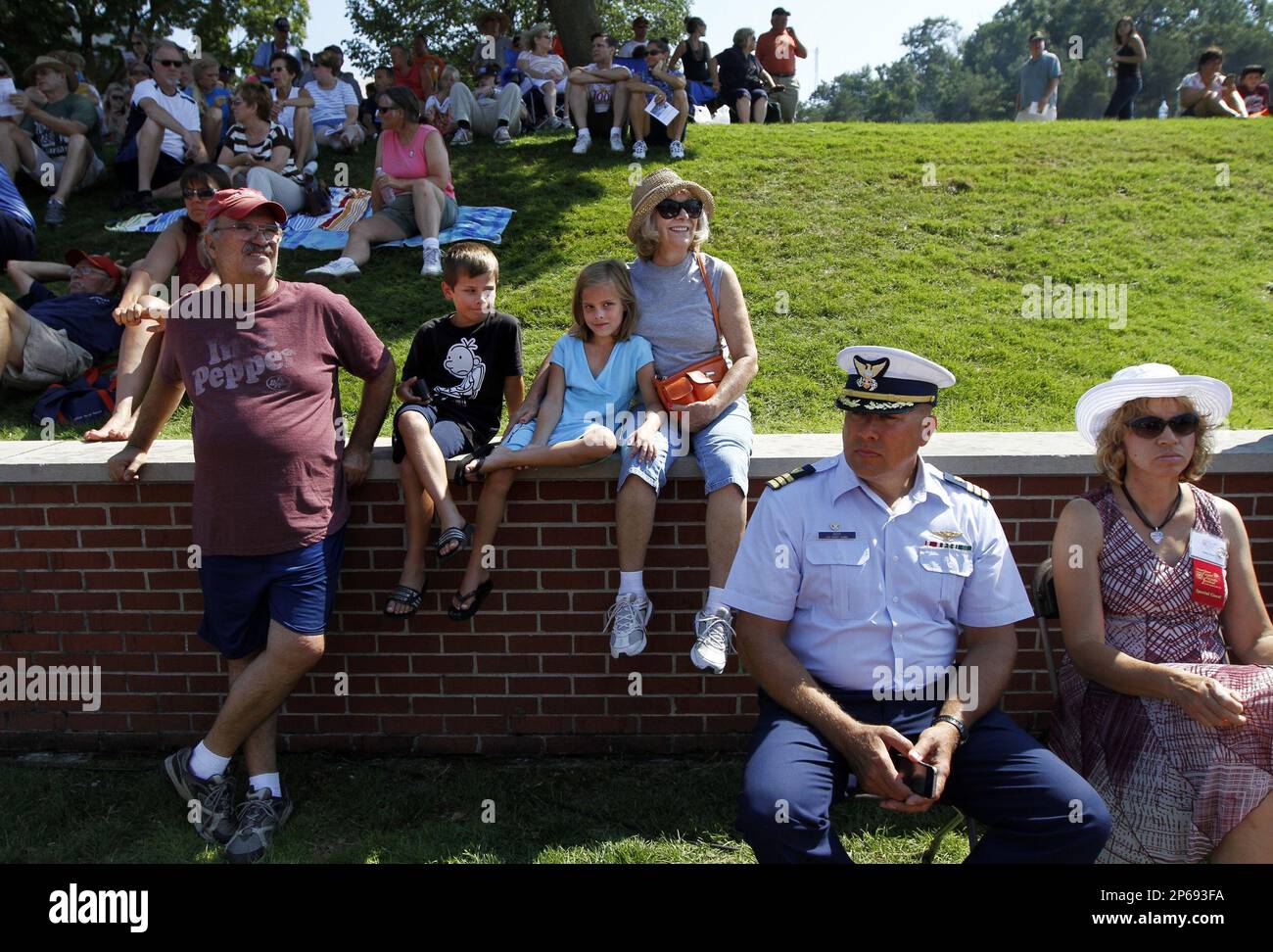 Owen, 8, and Maggie Winfield, 6, of Illinois, center, wait with their ...