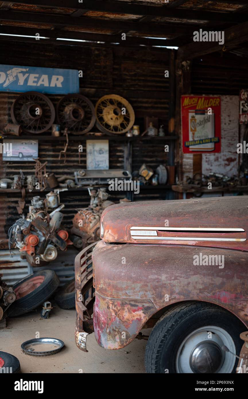Old abandoned car mechanic shop on the desert road. Inside is an old ...