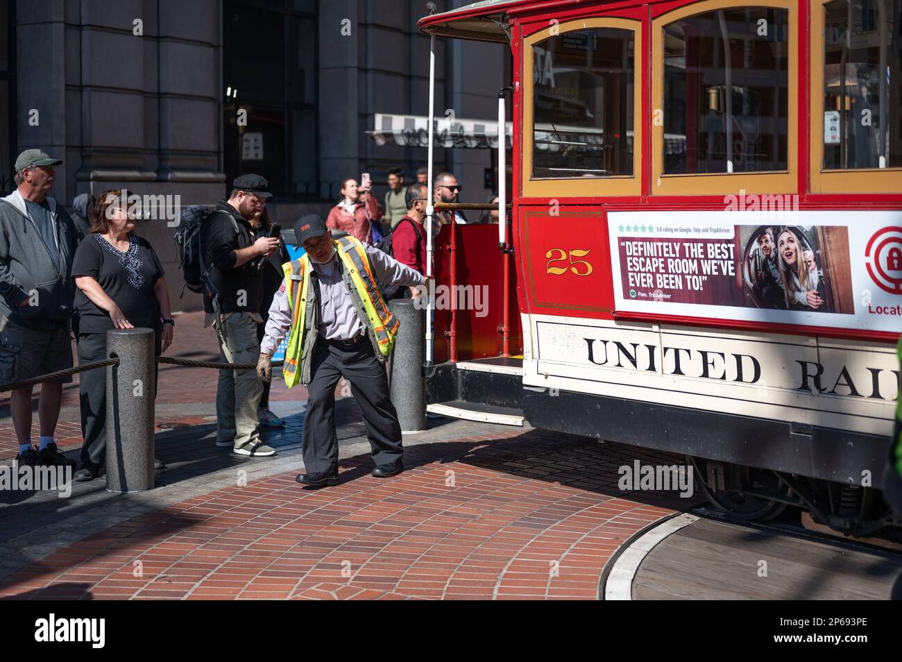 Detail of the operator turning the tram manually by pushing on the ...