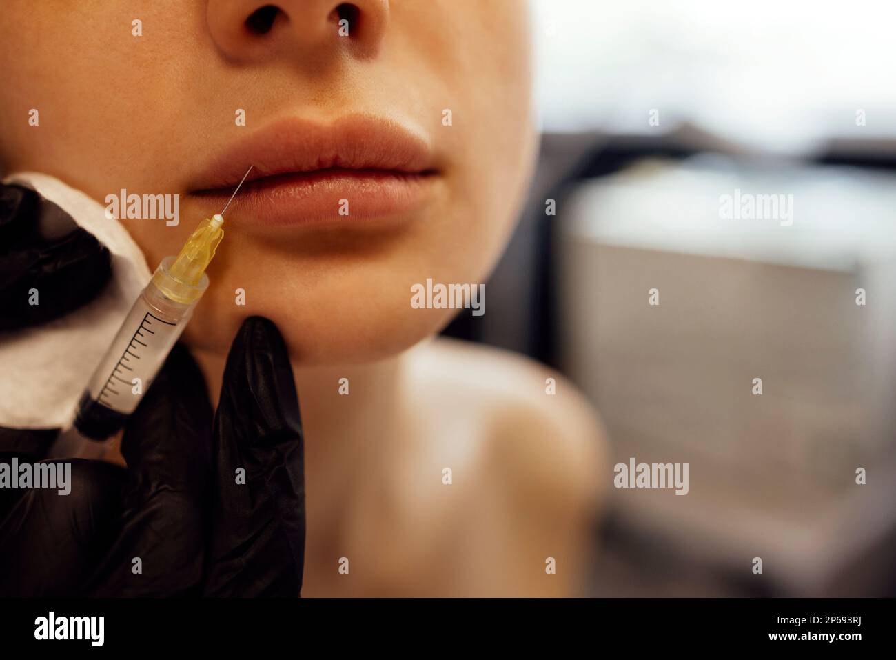 Beauty injections. Female cosmetologist in transparent gloves makes an ...