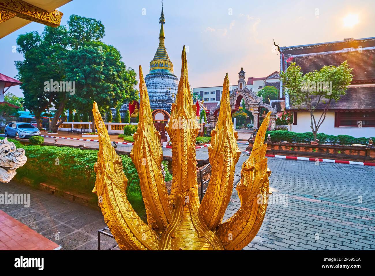 The five-headed golden Naga serpent against the medieval chedi and ...