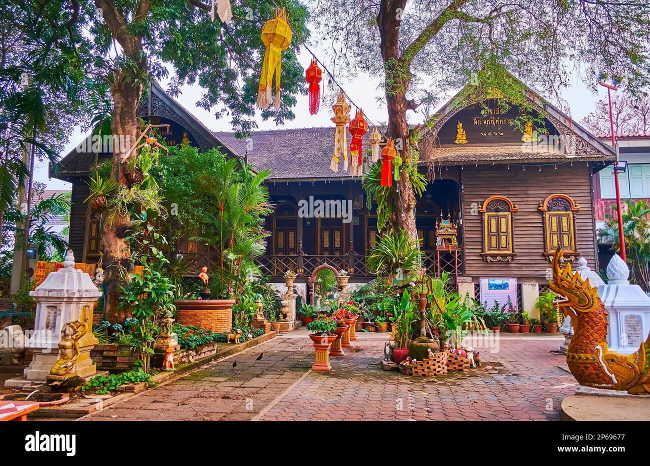 The green garden of Wat Ket Karam with colored Lanna lanterns, flowers ...