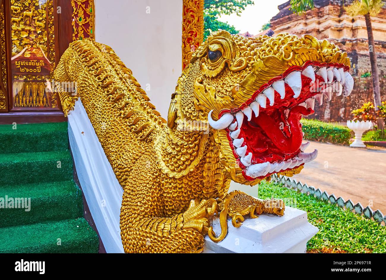 The beautiful gilt Mom aquatic creature statue guards the Ubosot of Wat ...