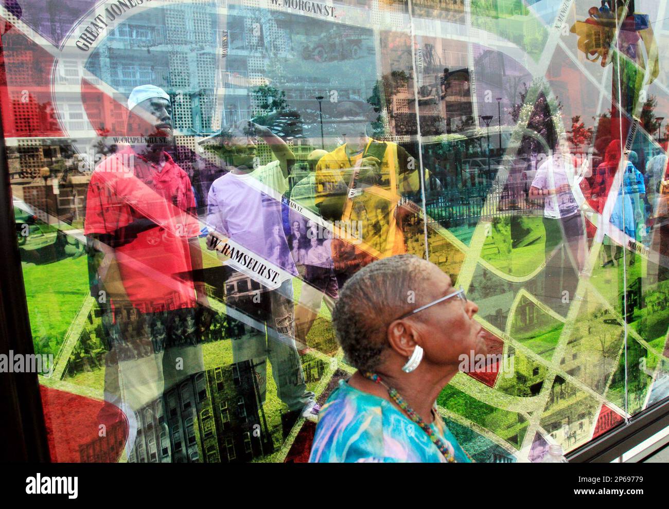 Myrele Douglas, front, waits for the Bull City Connector in Durham, N.C ...