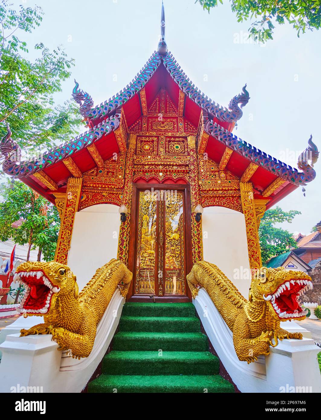 The Ubosot of Wat Umong Mahathera Chan is richly decorated with mirror ...