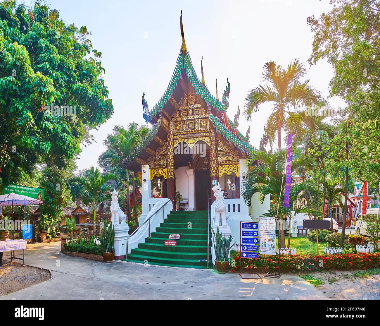 The carved wooden Viharn of Wat Umong Mahathera Chan is decorated with ...