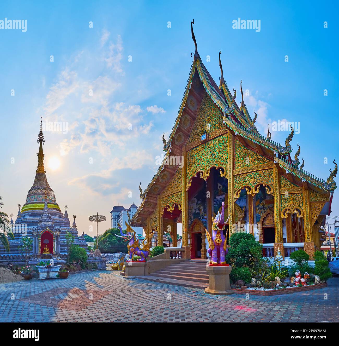 The sculptured Chedi and richly decorated Viharn of Wat Chetawan ...