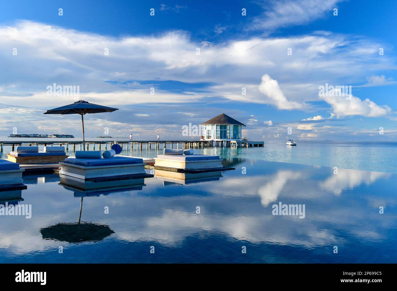 Early morning view of infinity pool and wooden of five-star resort ...