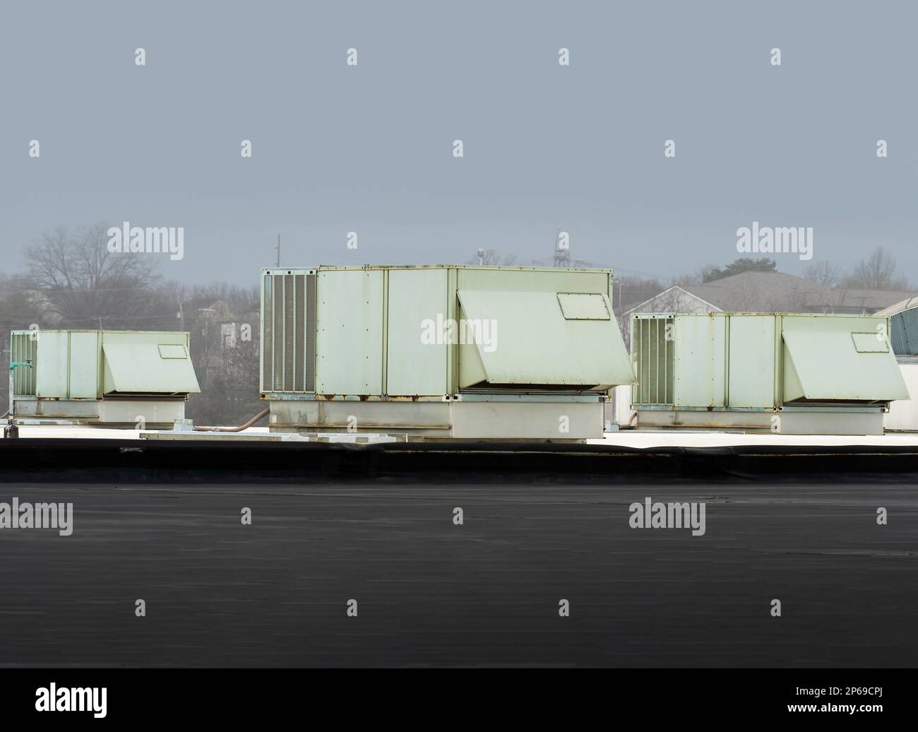 Horizontal shot of rooftop air conditioning units on top of a retail ...