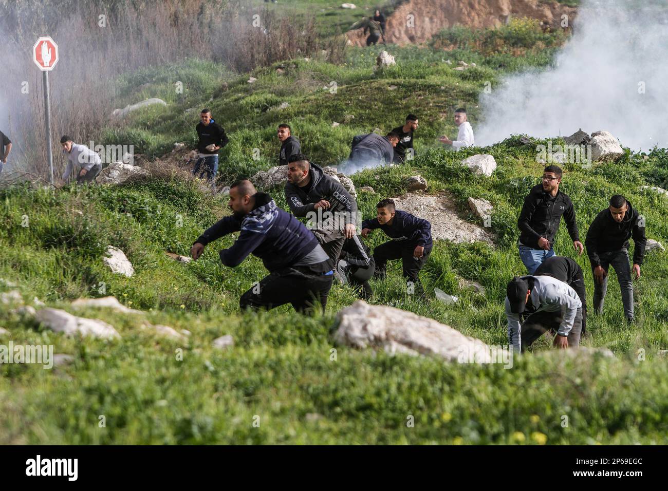 Palestinian youth throw stones at the Israeli army vehicles, in the ...