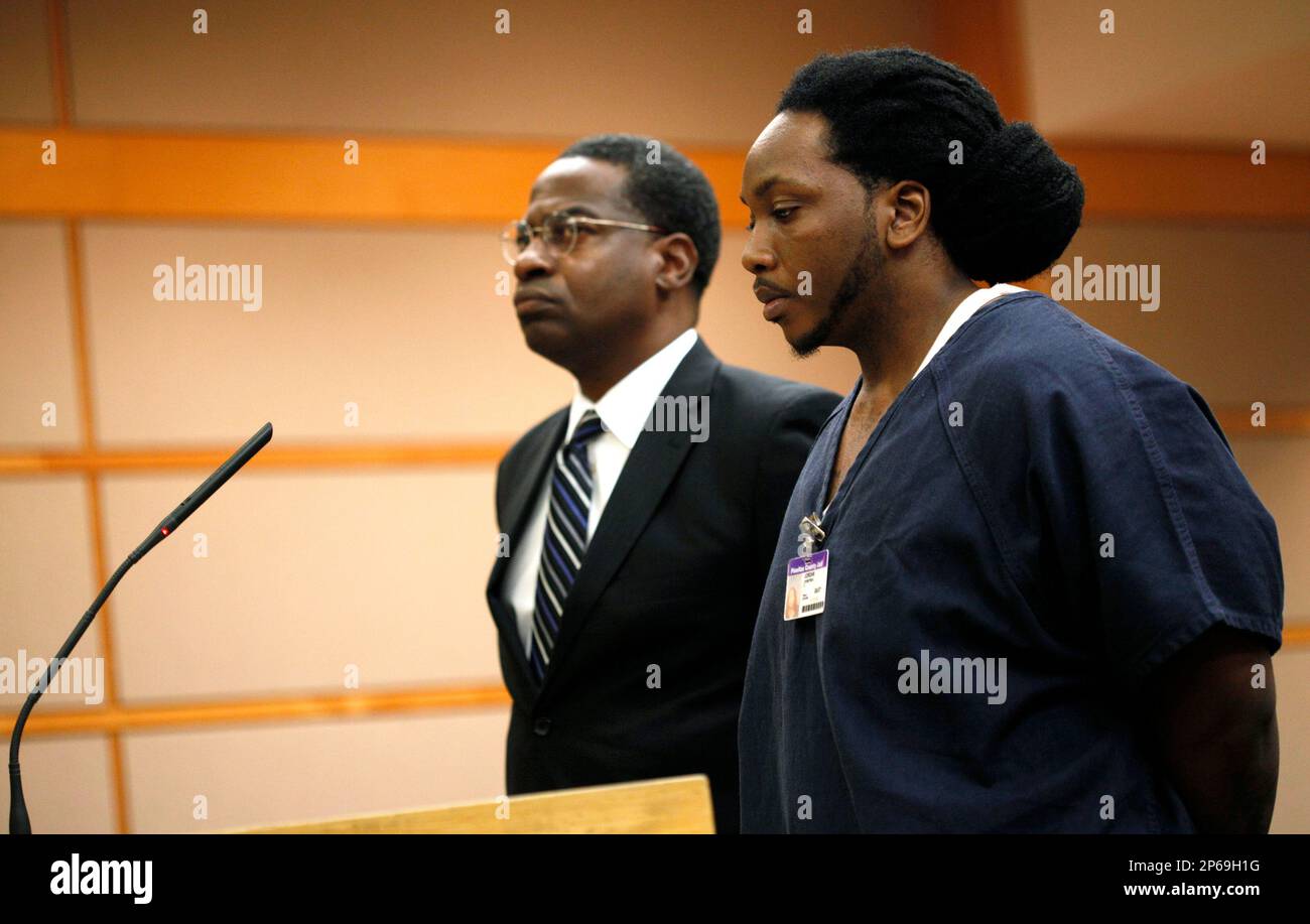 Attorney Carl Roland Hayes, left, stands by as Demetrius Jordan is ...