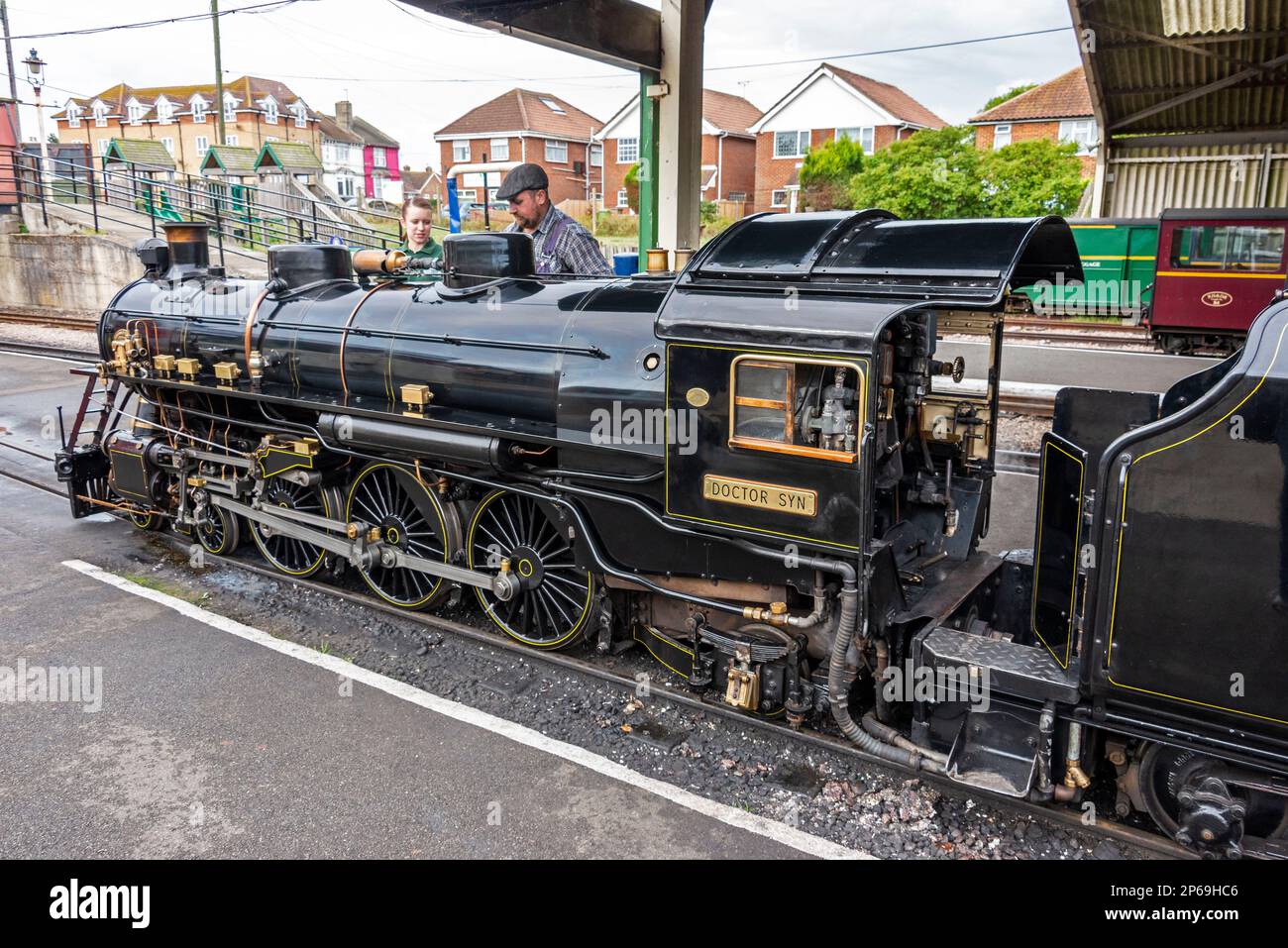 An engine driver gives a final clean before the small steam locomotive ...