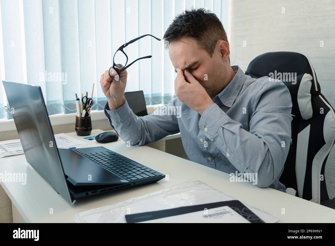 Businessman office working holding sore head pain from desk working and ...