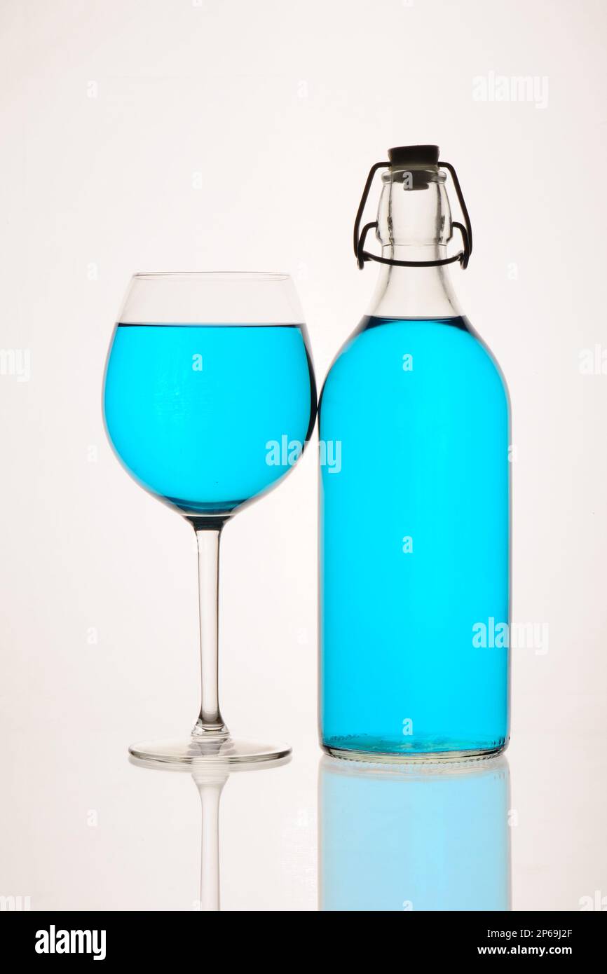 special bottle with a glass on a white background Stock Photo - Alamy