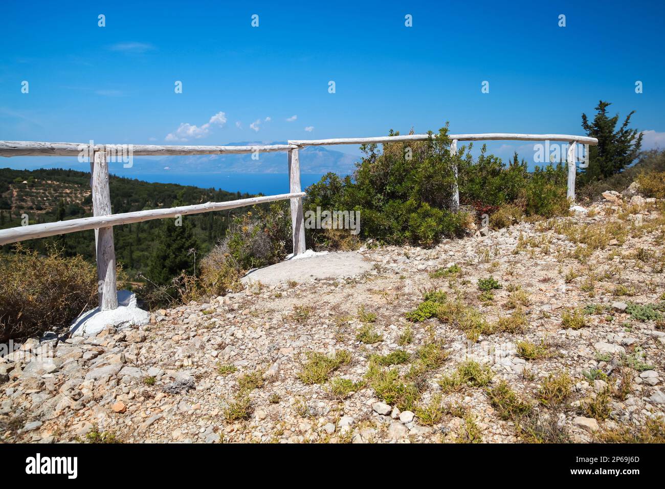 Summer landscape with white wooden railings along a mountain trail ...