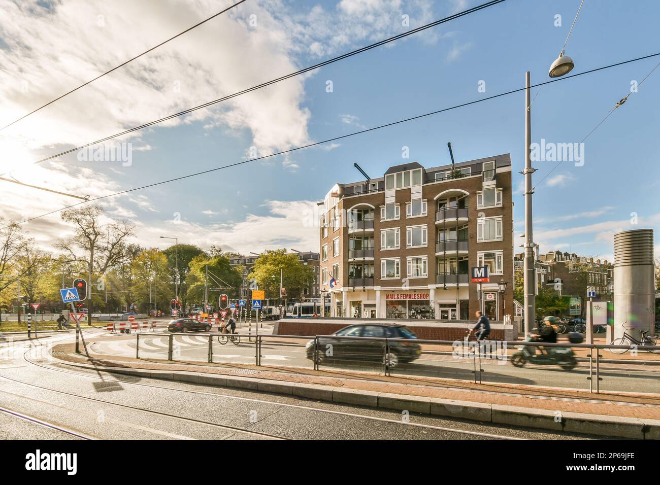 a city street with cars and people walking on the sidewalk in front of ...