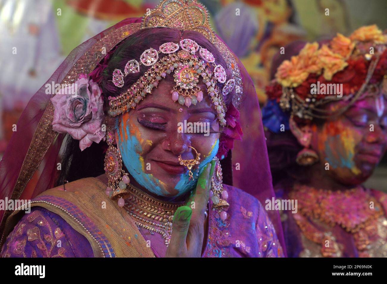 March 7, 2023, Kolkata, India: Devotees smear color to a woman dressed ...